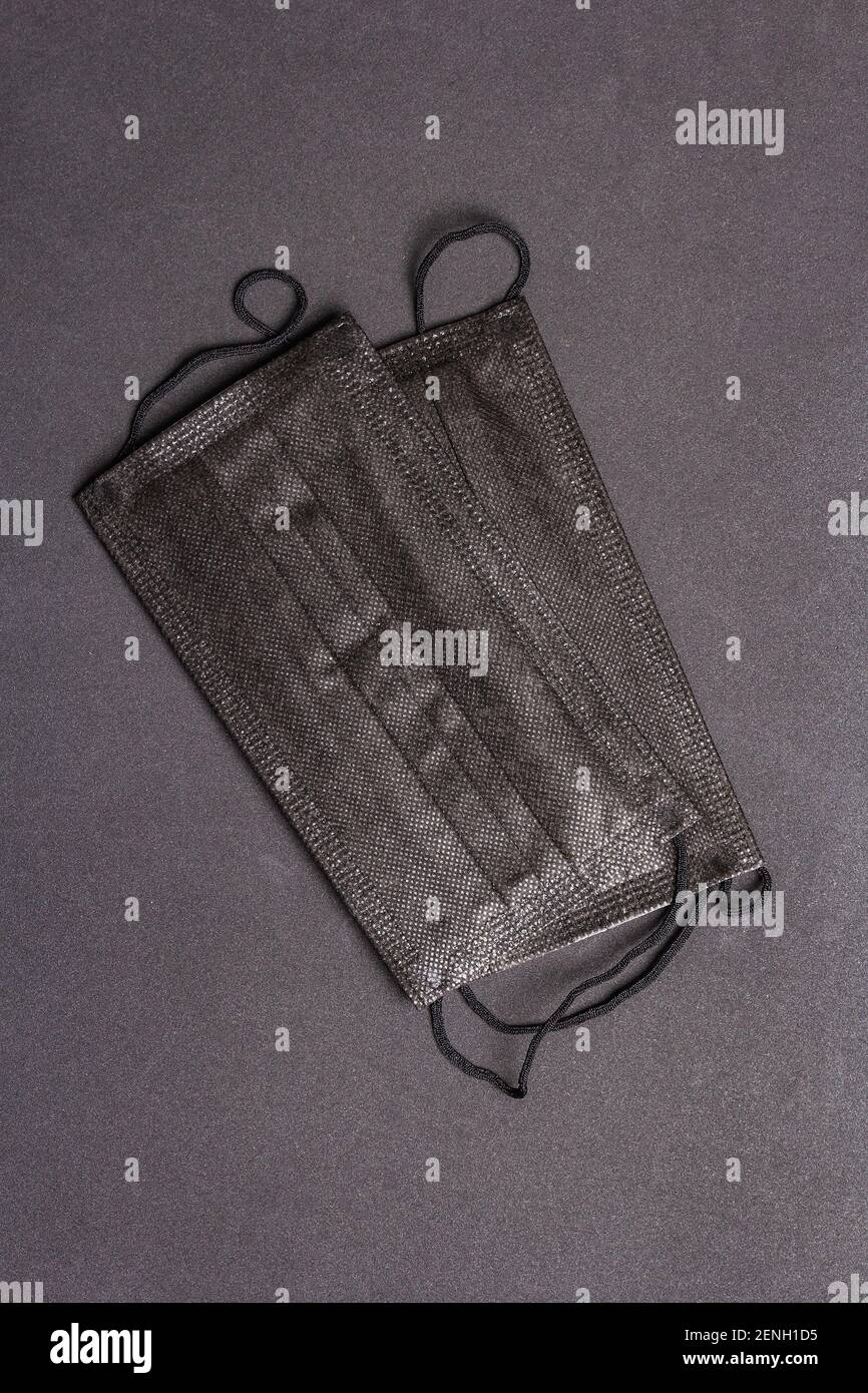 Black masks isolated on dark background. Medical products for personal ...