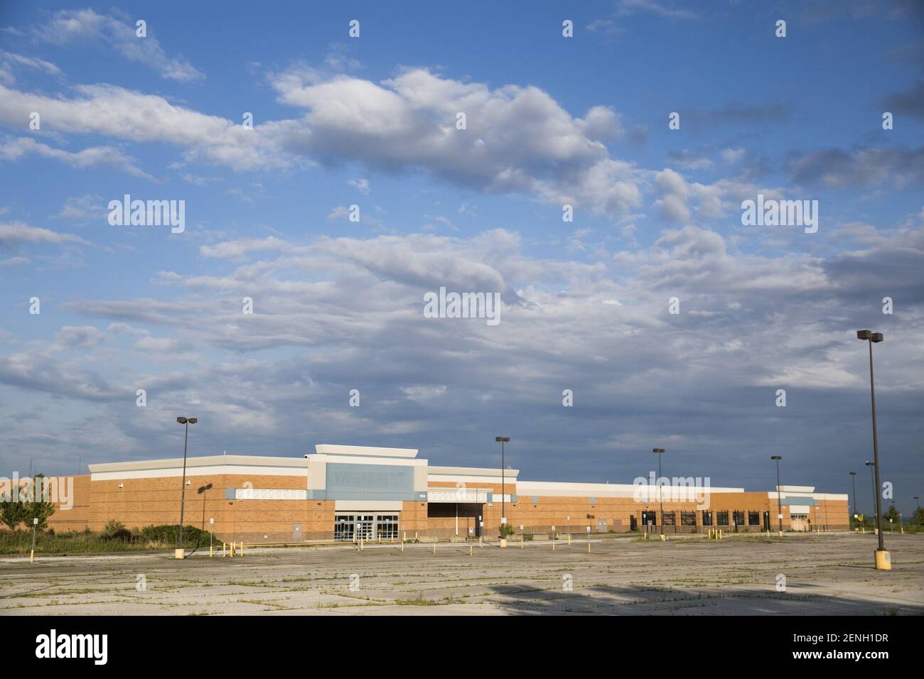 The faded outline of a Walmart logo sign at a closed and abandoned ...