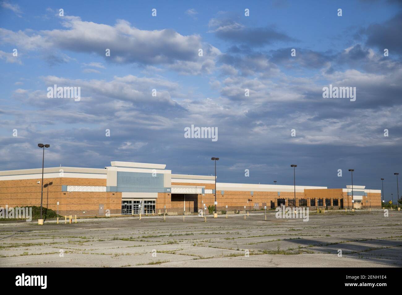 The faded outline of a Walmart logo sign at a closed and abandoned ...