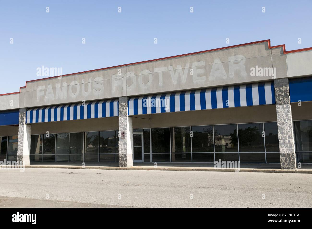The faded outline of a logo sign outside of a closed and abandoned ...