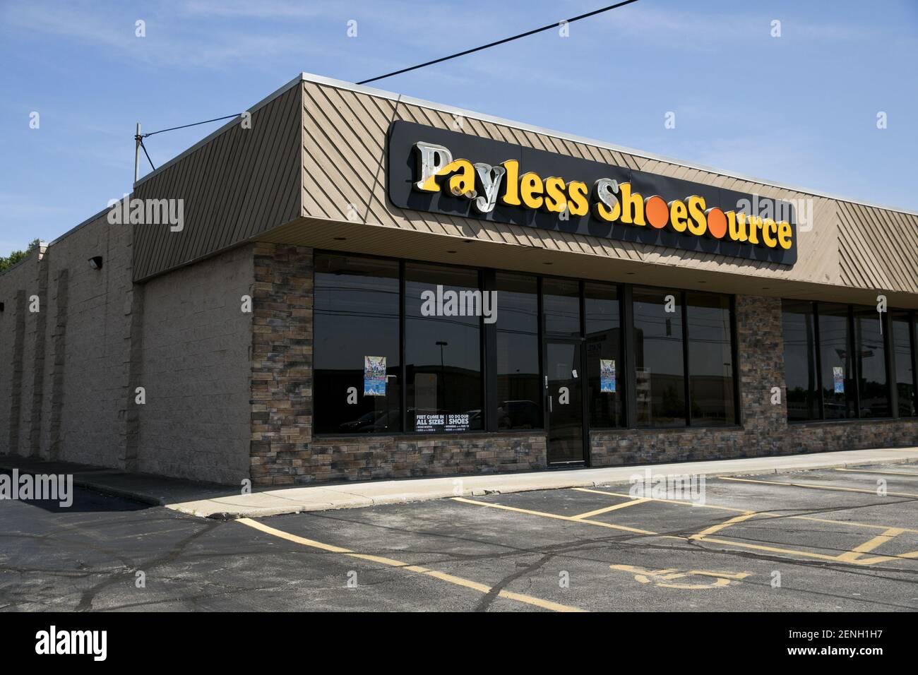 A logo sign outside of a closed Payless ShoeSource retail store ...