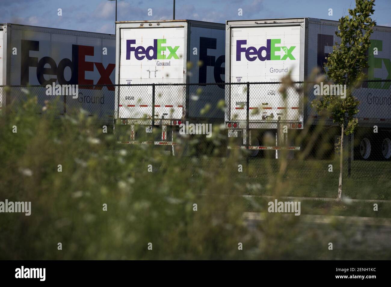 FedEx Ground logos on truck trailers at a FedEx distribution center in ...