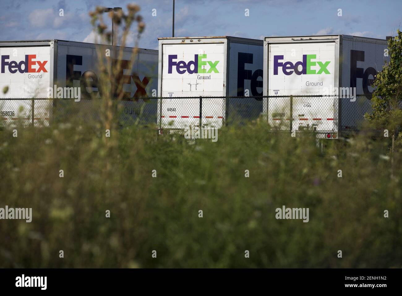 FedEx Ground logos on truck trailers at a FedEx distribution center in ...