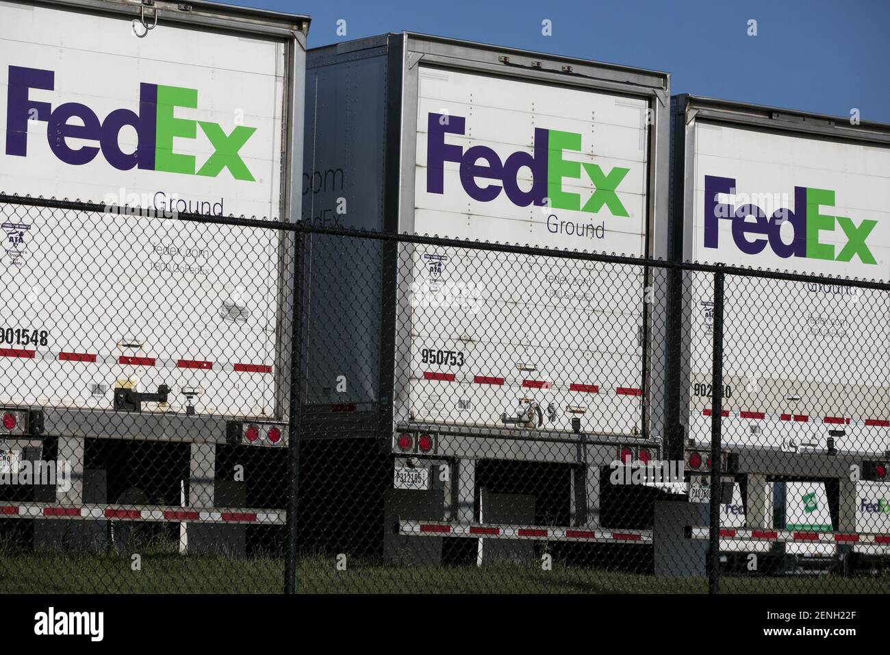 FedEx Ground logos on truck trailers at a FedEx distribution center in ...
