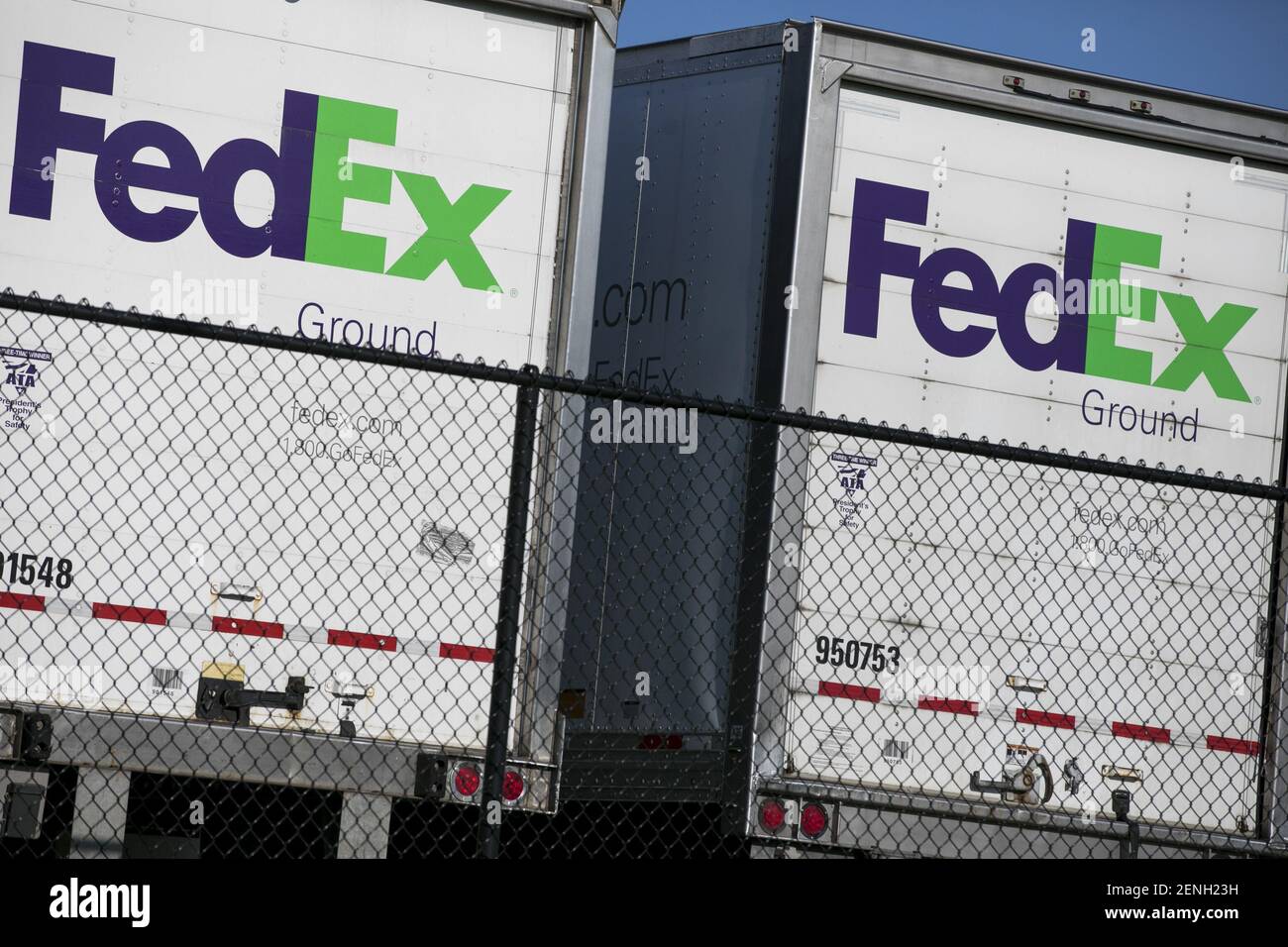 FedEx Ground logos on truck trailers at a FedEx distribution center in ...