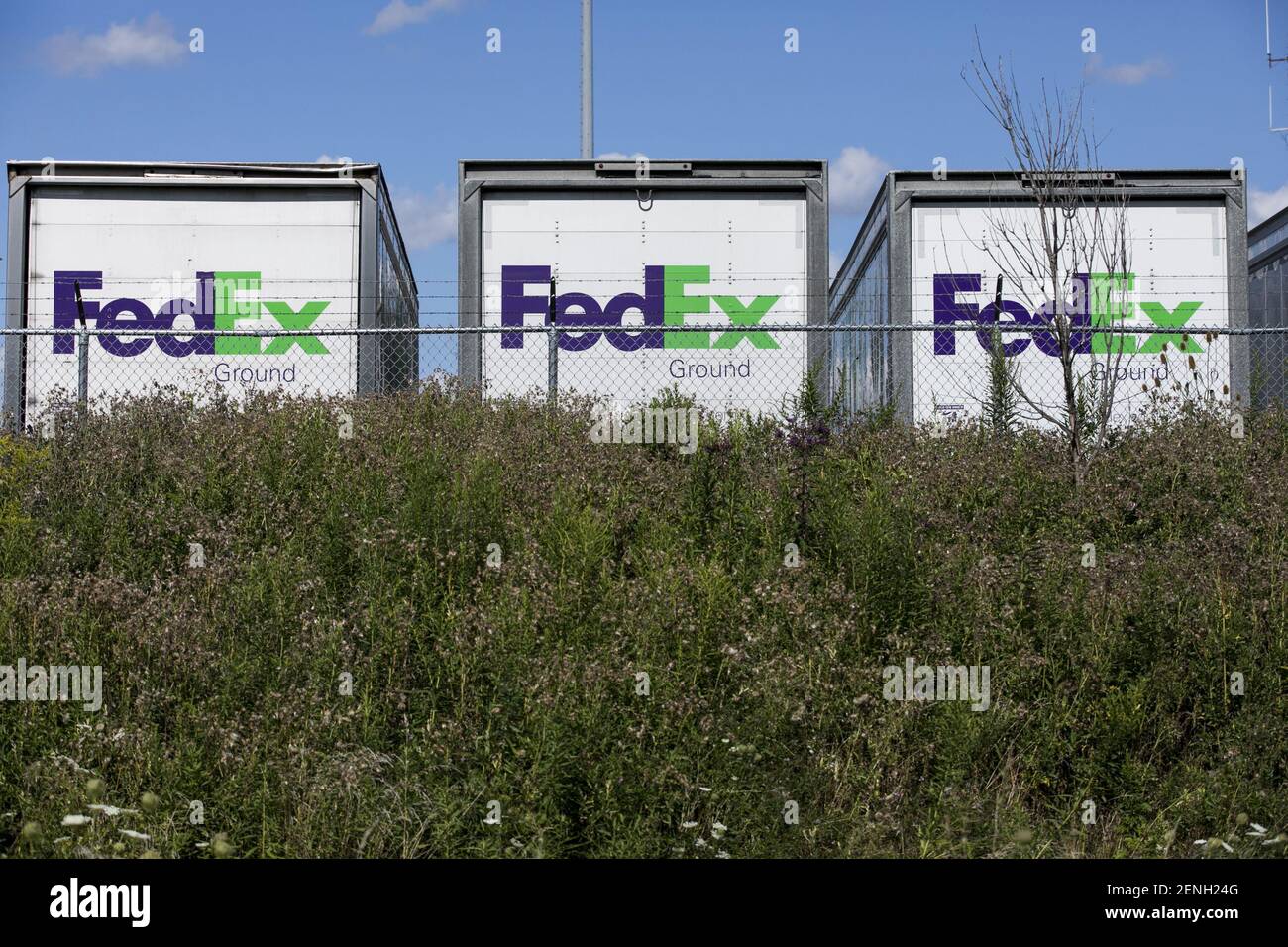 FedEx Ground logos on truck trailers at a FedEx distribution center in ...