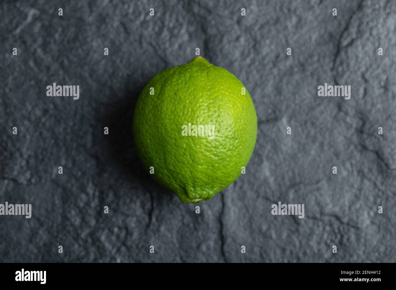 Close up photo of fresh ripe green lime on black background Stock Photo ...