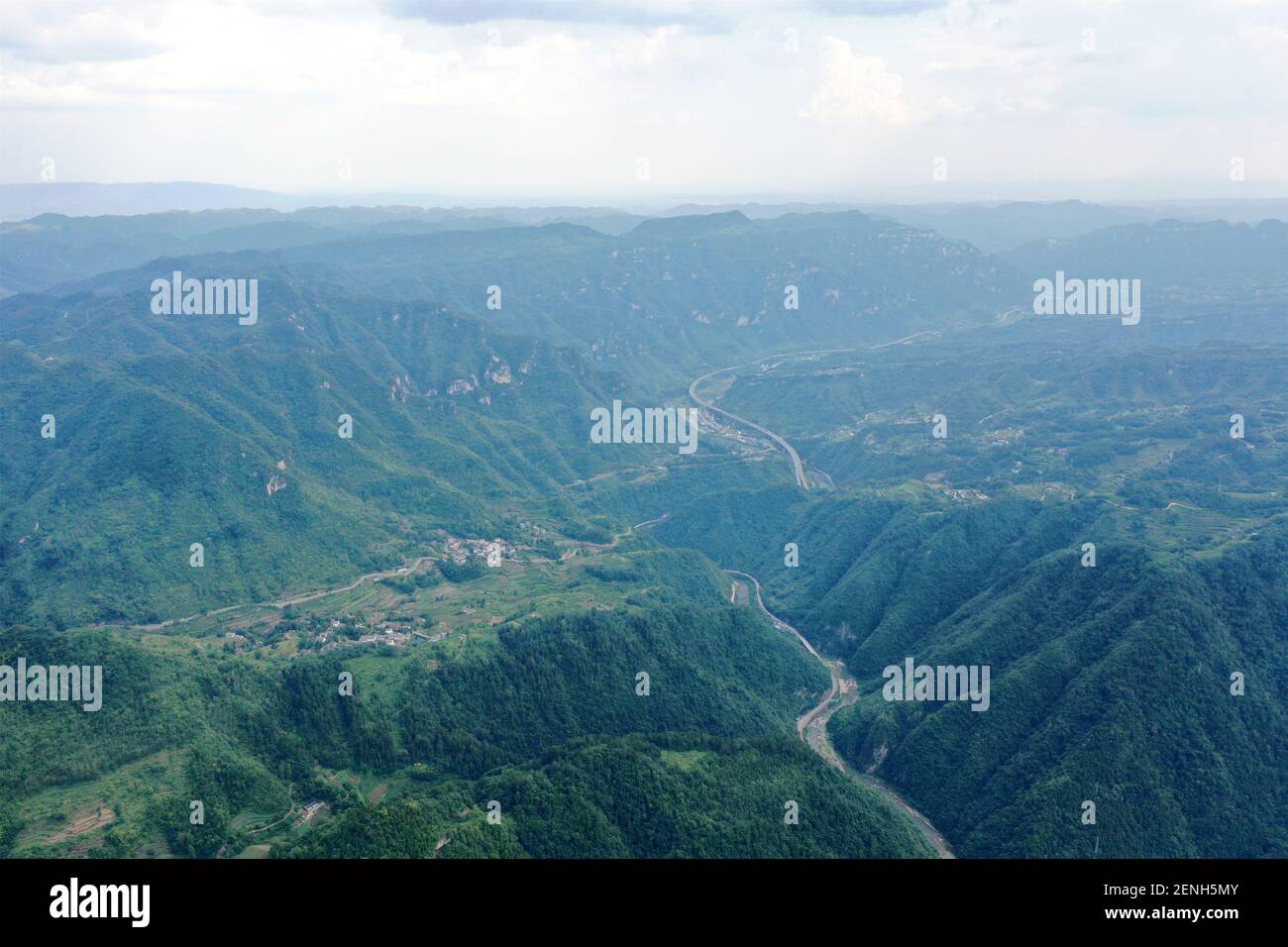 The view of mountains and river with village bungalows scattering ...