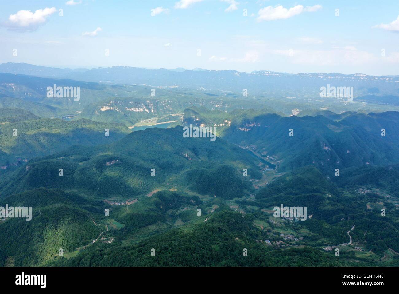 The view of mountains and river with village bungalows scattering ...