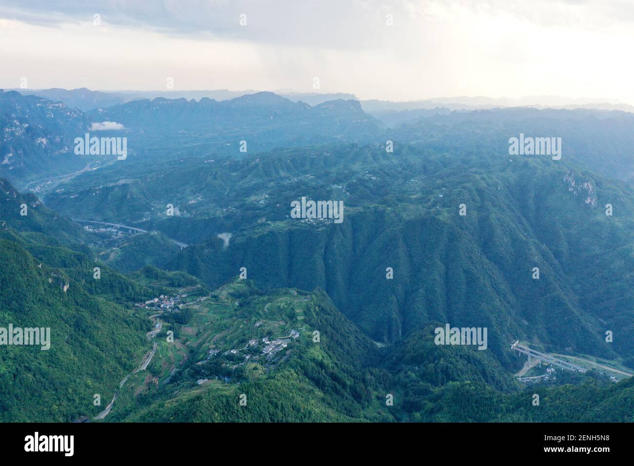 The view of mountains and river with village bungalows scattering ...