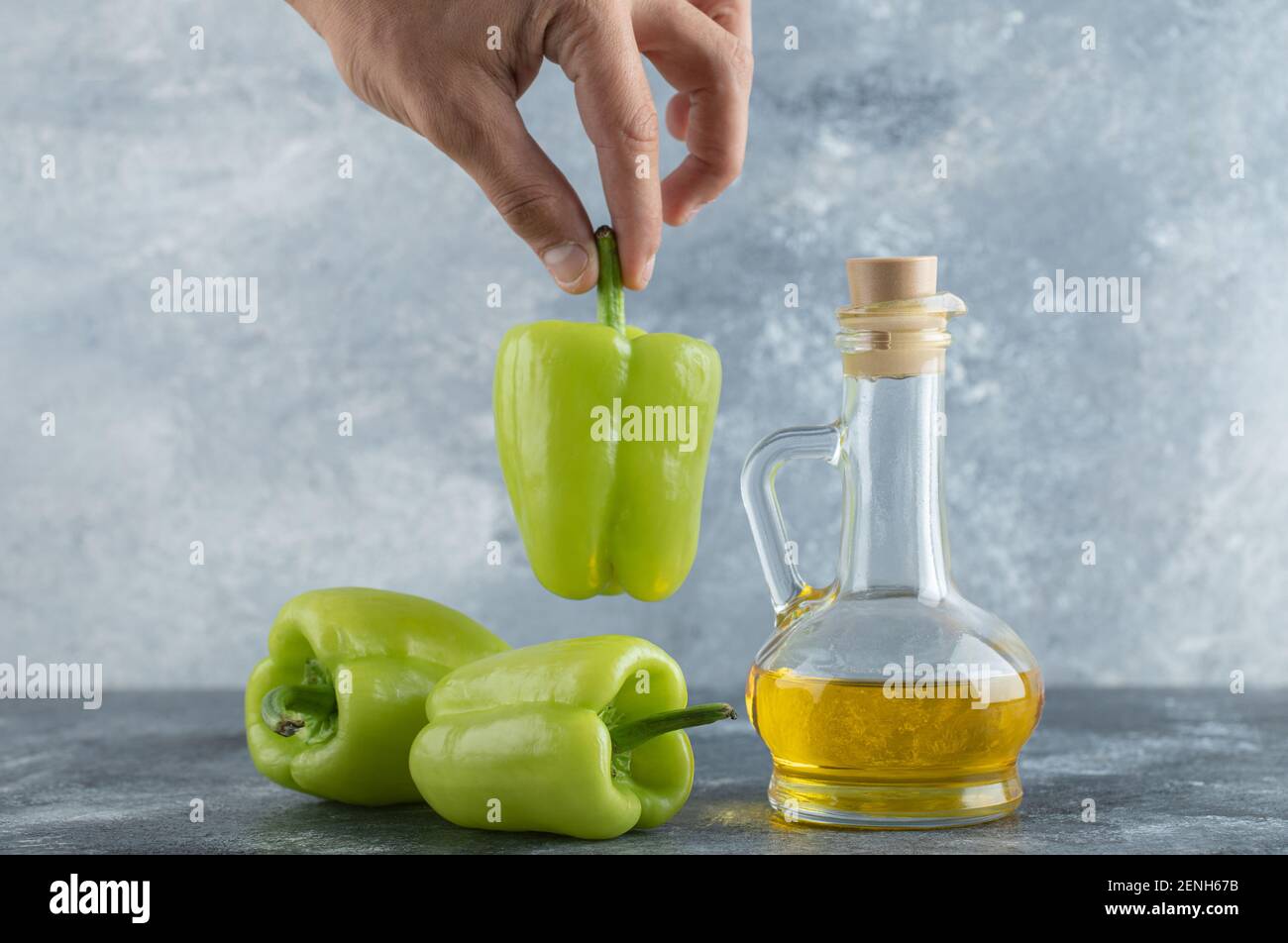 Male hand taking green pepper from the pile Stock Photo - Alamy