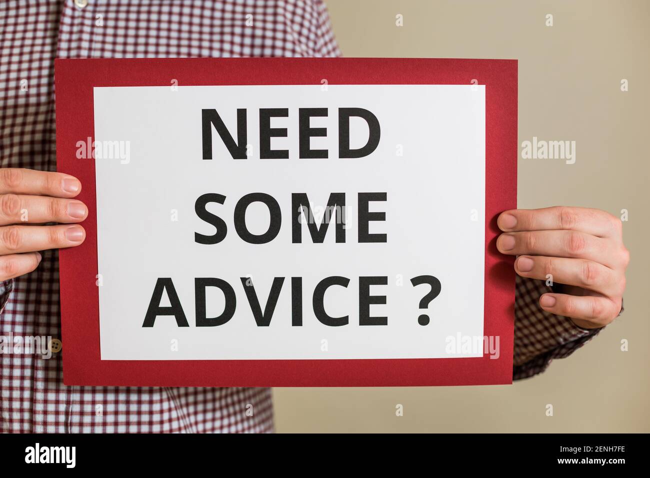 Image of man holding paper with text need some advice Stock Photo - Alamy