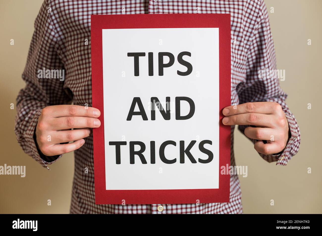 Image of man holding paper with text tips and tricks Stock Photo - Alamy