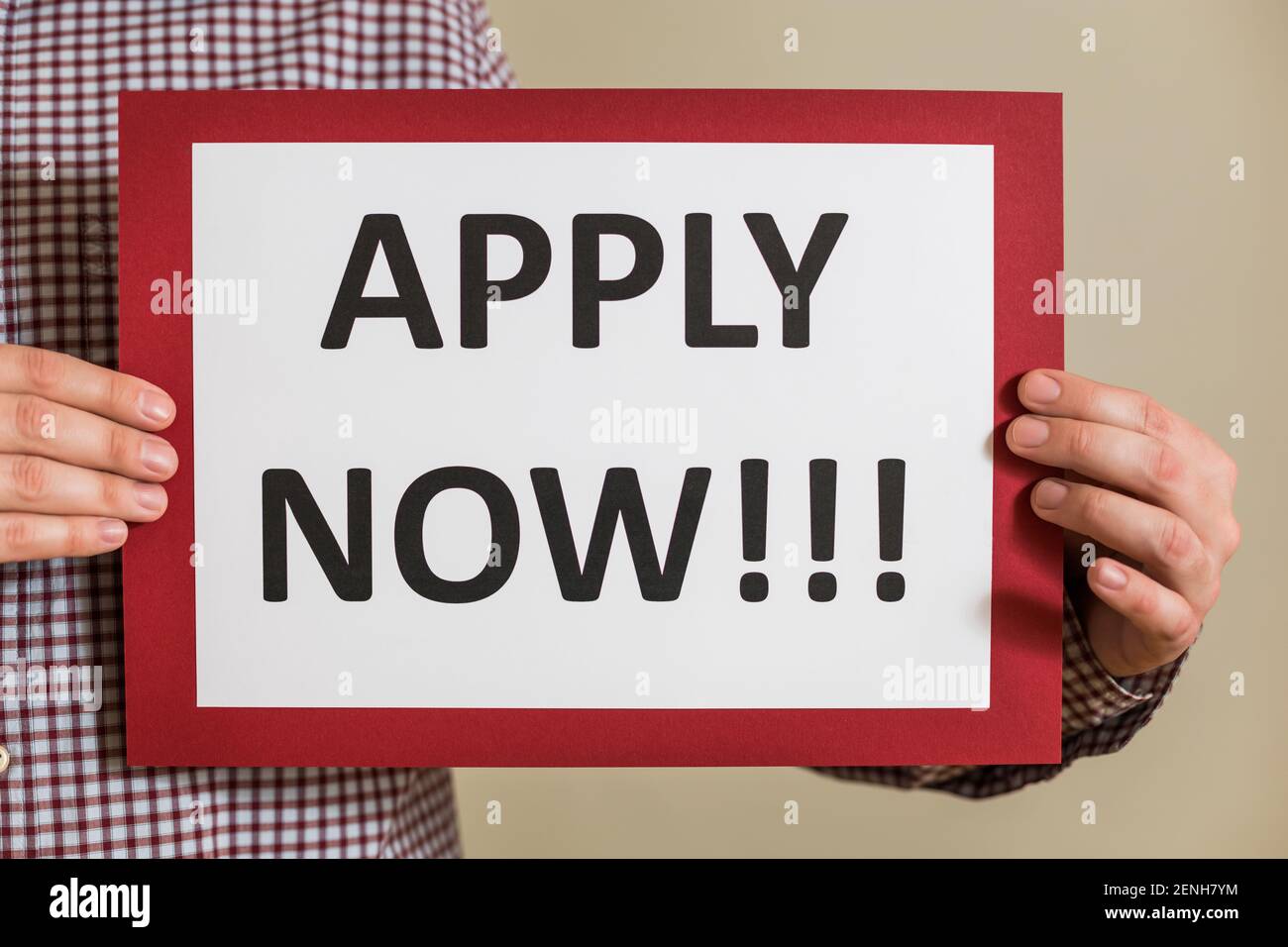 Image of man holding paper with text apply now Stock Photo - Alamy