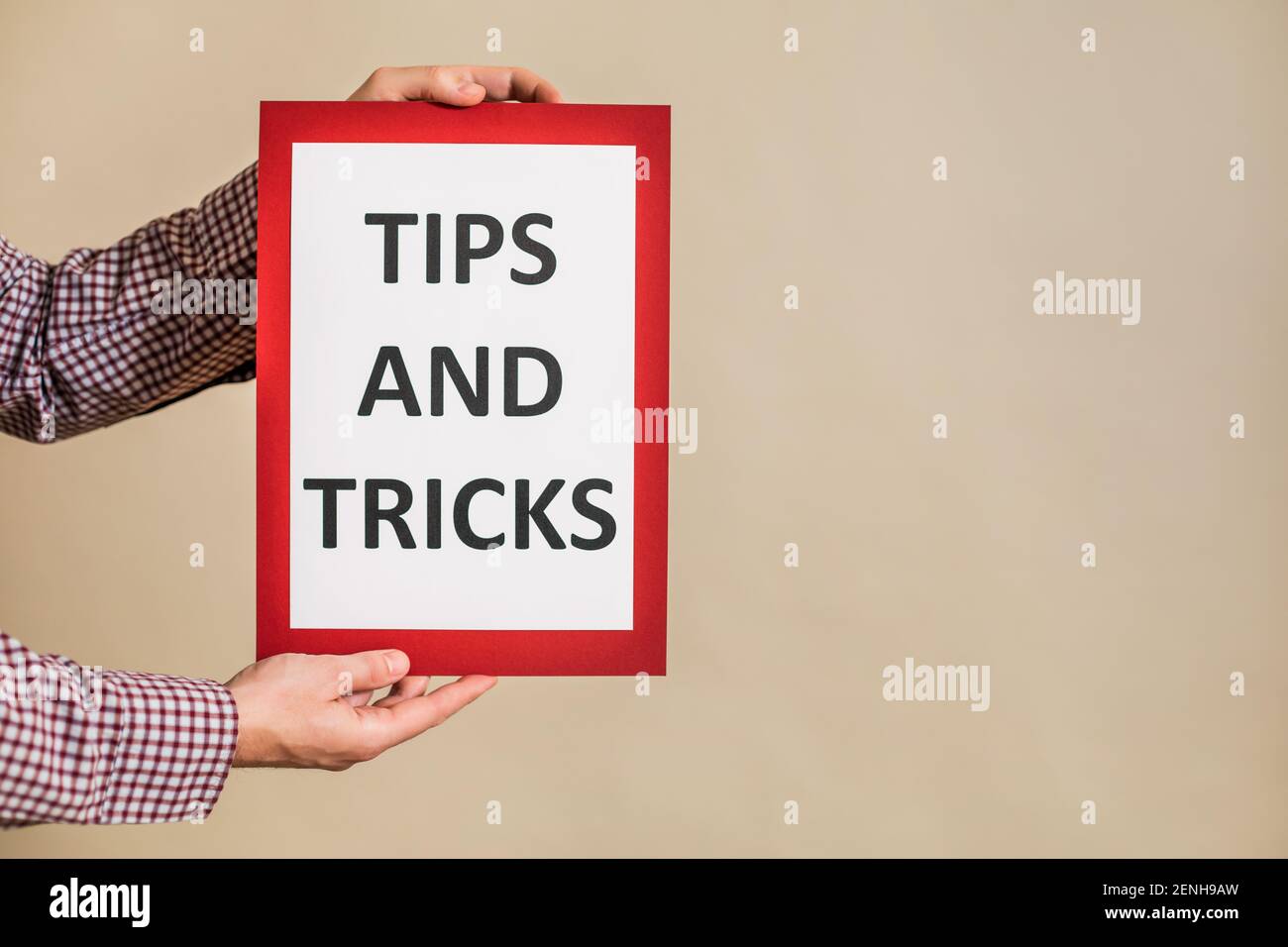 Image of man holding paper with text tips and tricks Stock Photo - Alamy
