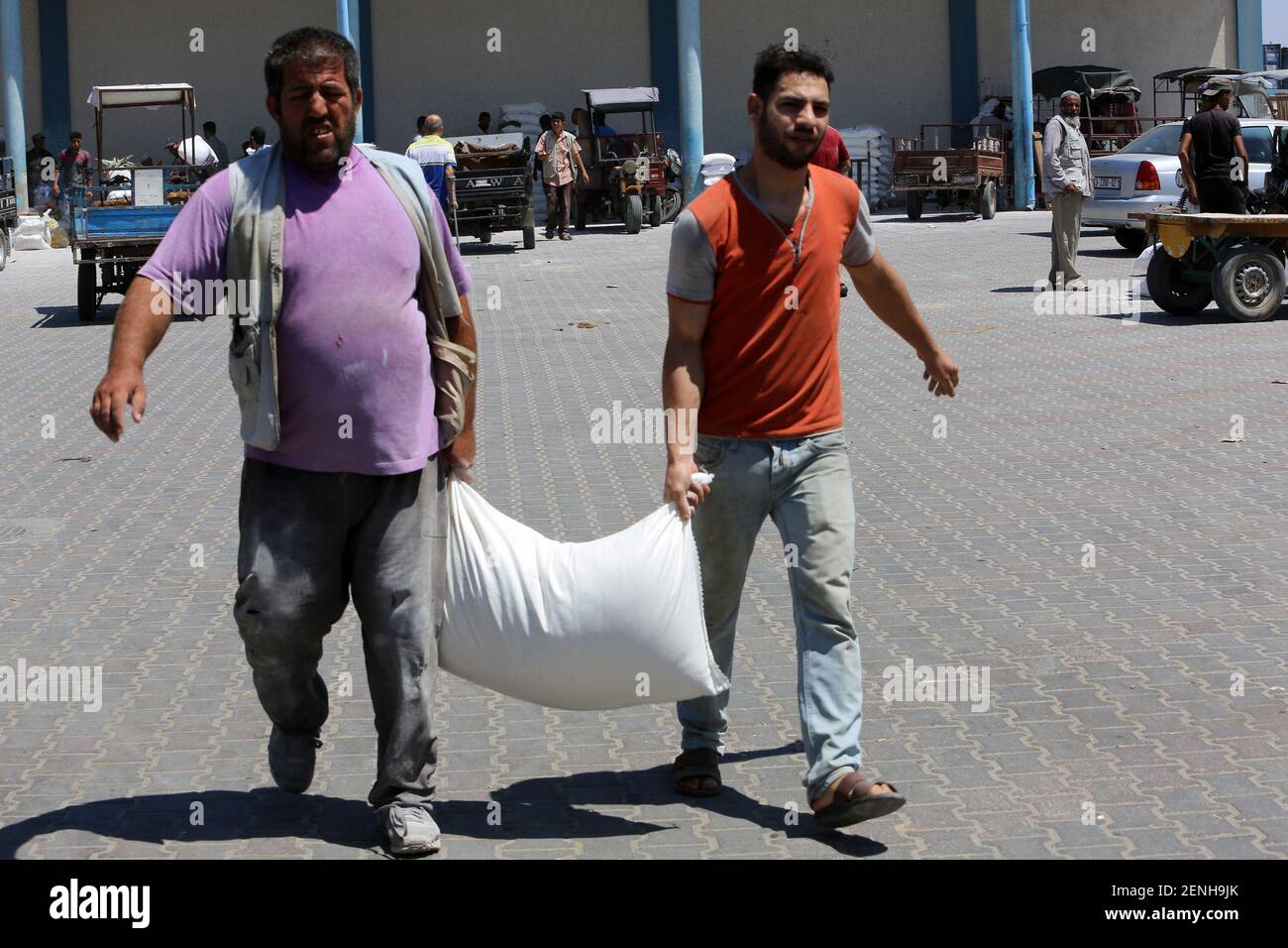 Palestinians receive their monthly food an aid distribution centre run ...