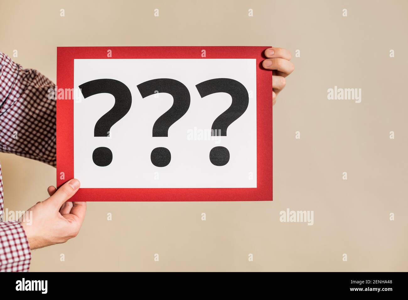 Man showing paper with question marks Stock Photo - Alamy