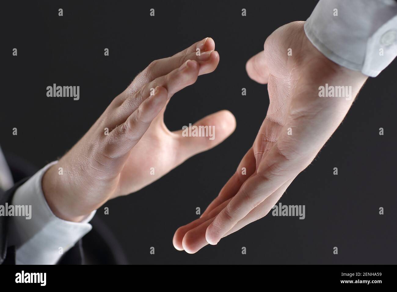 two businessmen are holding out their hands for a handshake Stock Photo ...