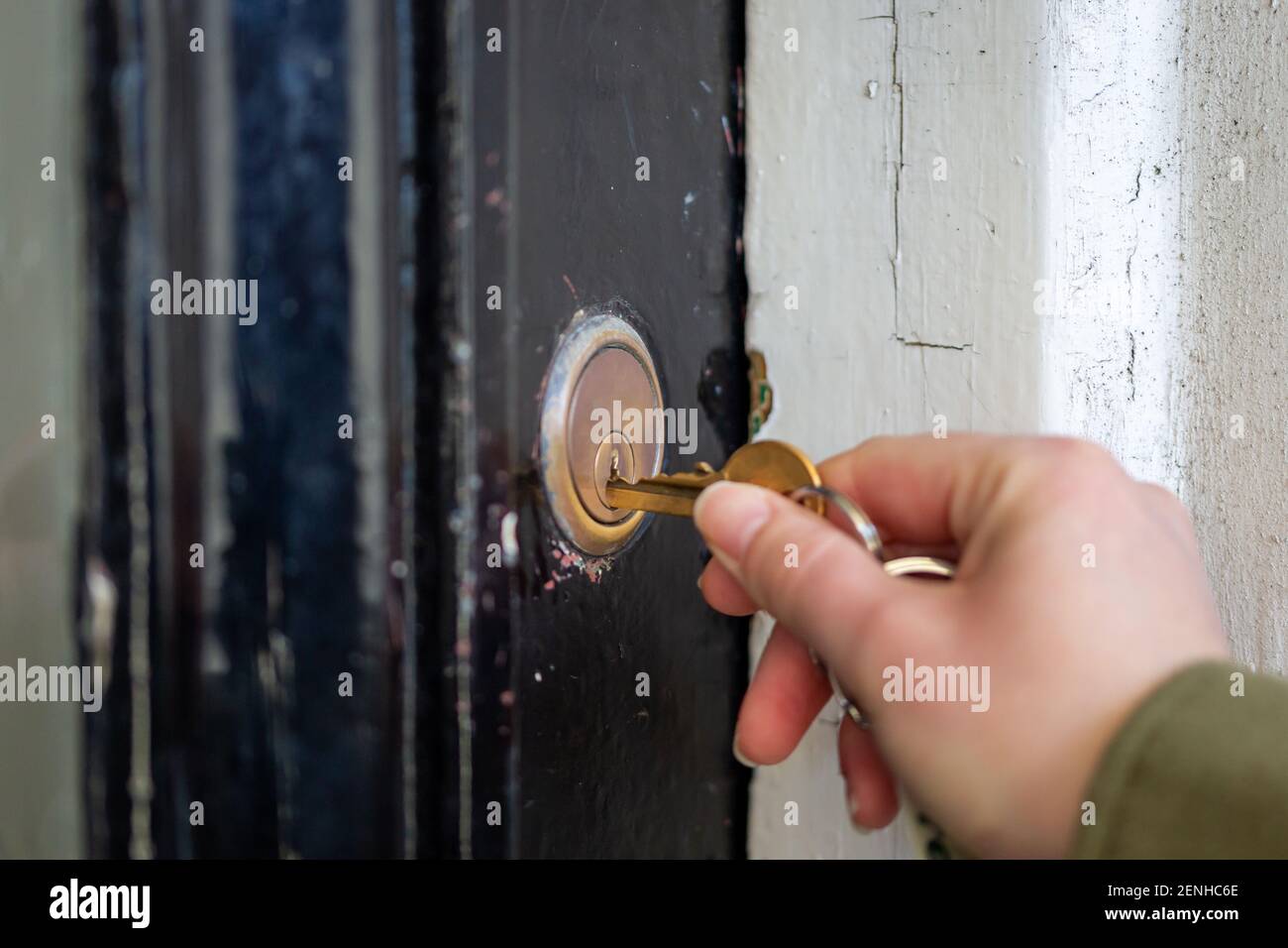 A key being put into the lock on a front door Stock Photo - Alamy