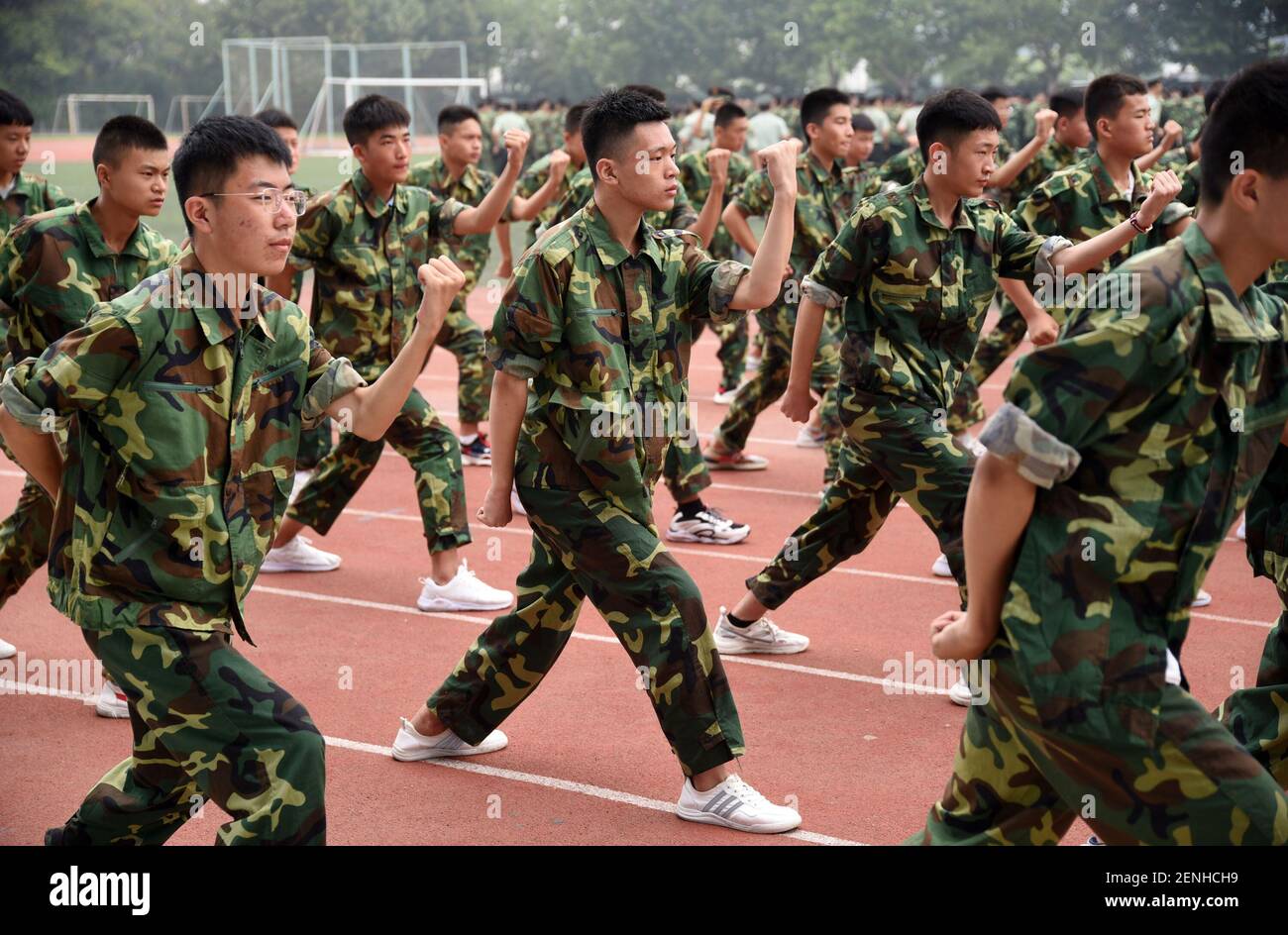 Chinese freshmen students exercise during a military training session ...
