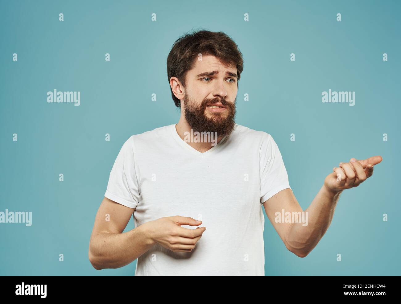 Emotional guy gesturing with his hands on a blue background Copy Space ...