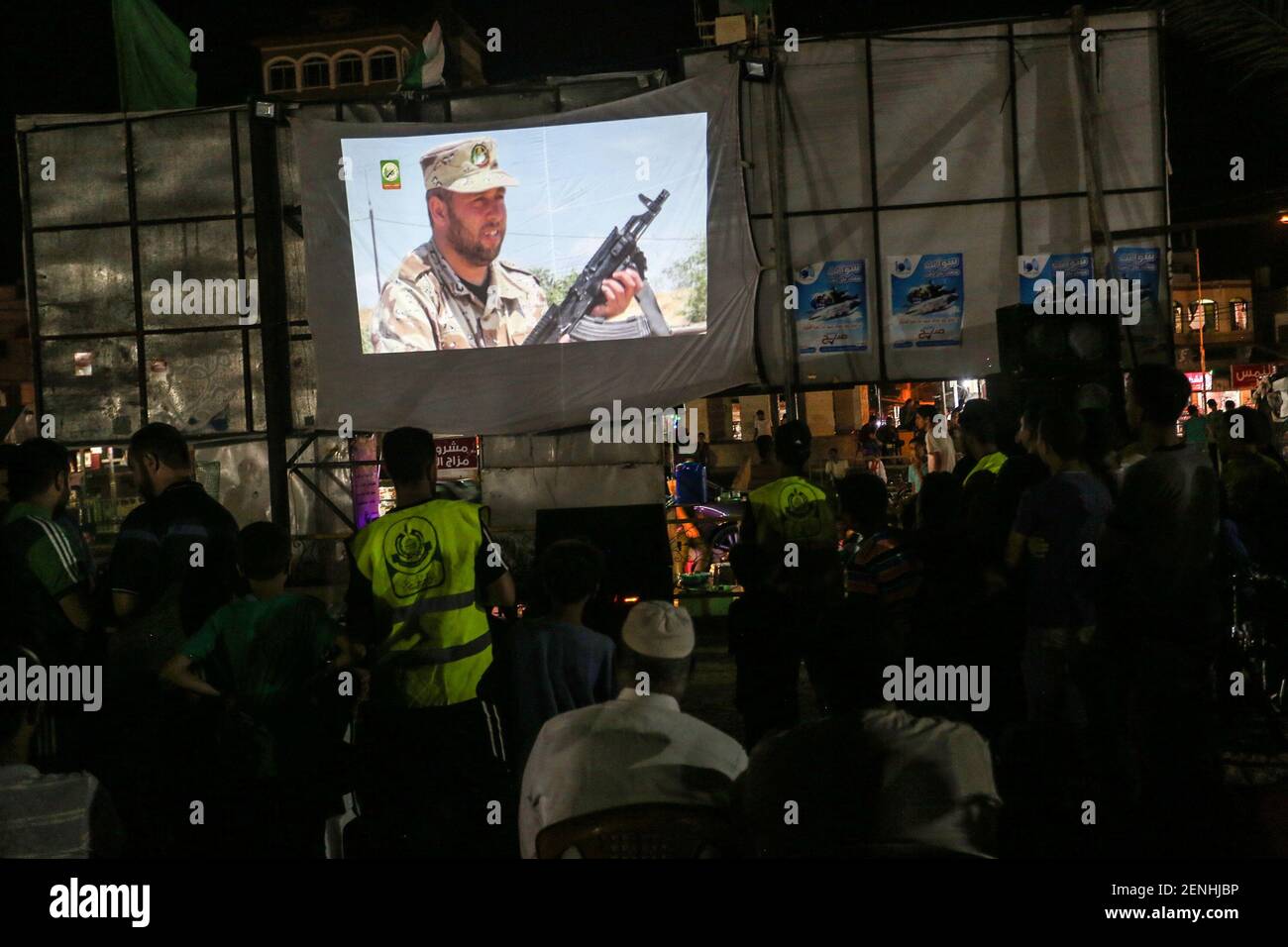 Palestinians watch video on a large screen, the fifth anniversary of ...