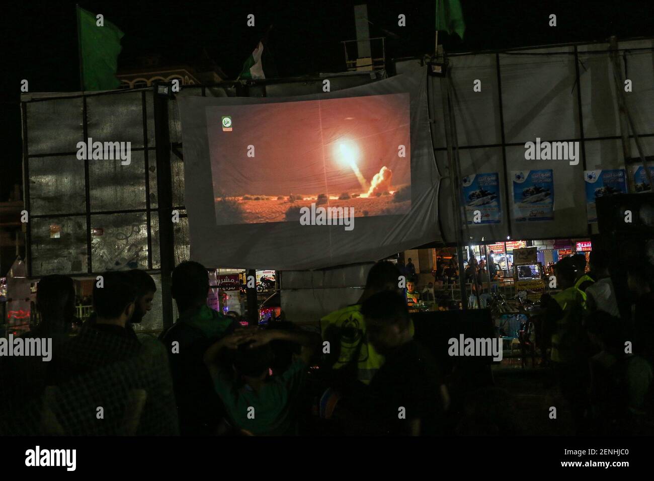 Palestinians watch video on a large screen, the fifth anniversary of ...