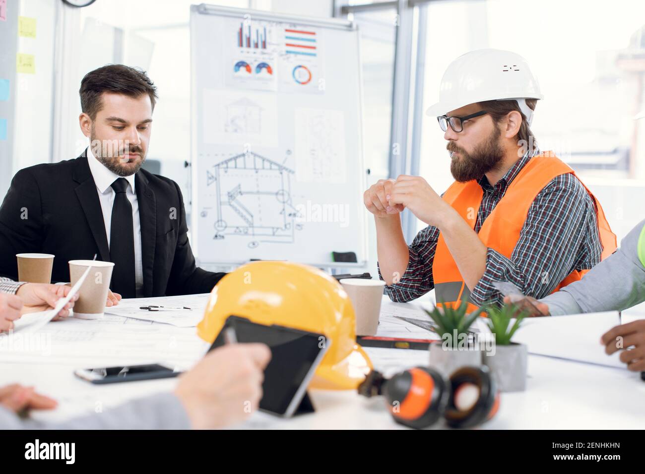 Team of construction designers planning project at office Stock Photo ...