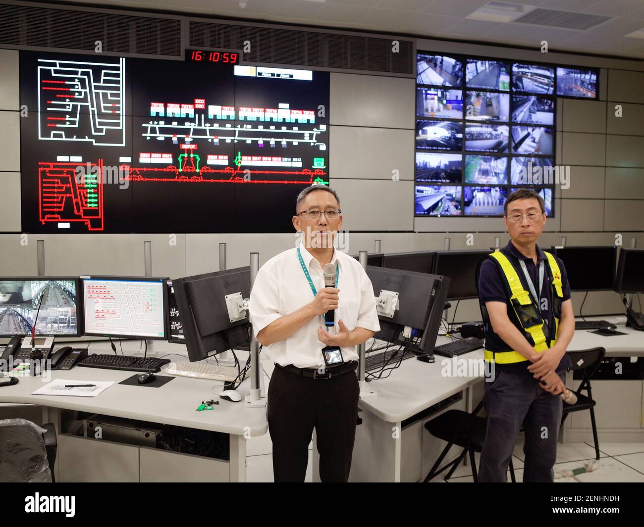Chinese workers introduce the Light Rail Transit (LRT) system at the ...