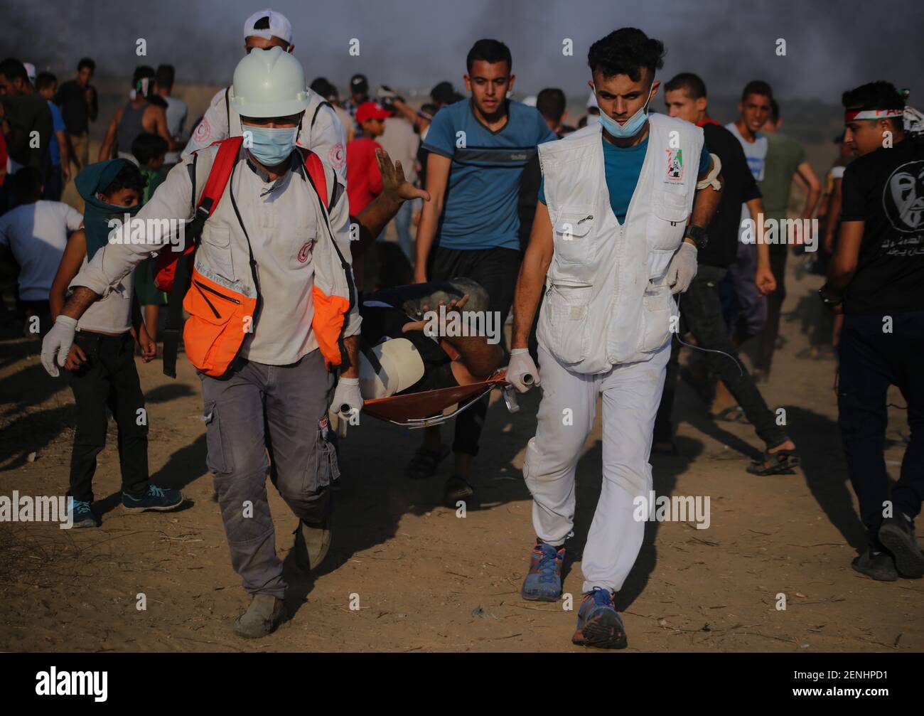 Palestinian medics carry a wounded person during the during an anti ...