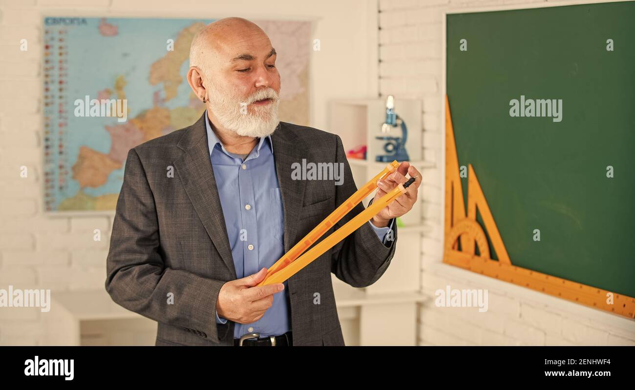 Senior intelligent man teacher at chalkboard. Education goals. School ...