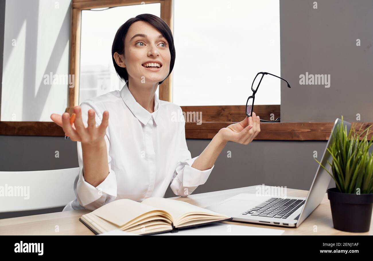 Business woman sitting at work table in front of laptop finance office ...
