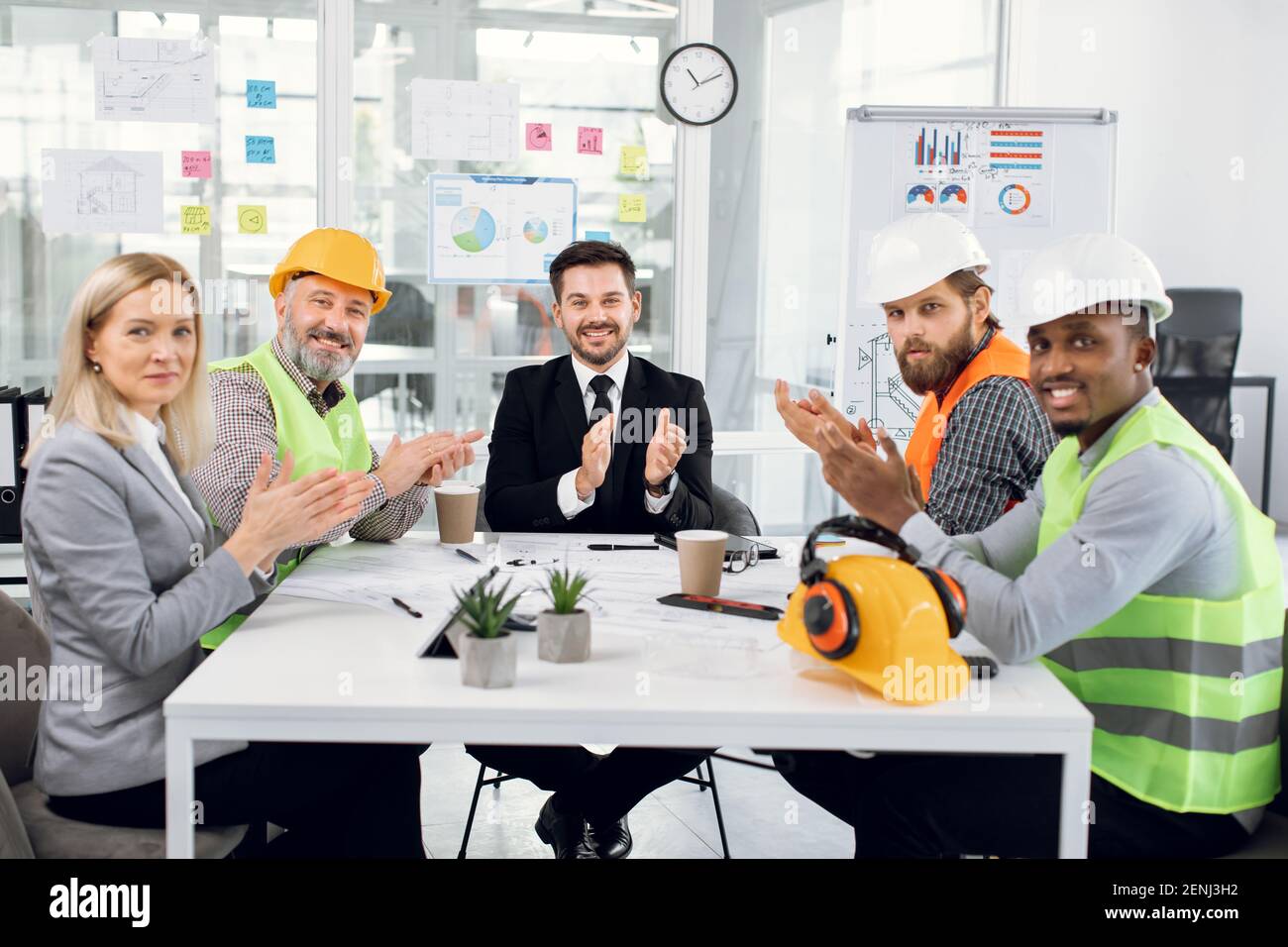 Construction team clapping hands after successful meeting Stock Photo ...
