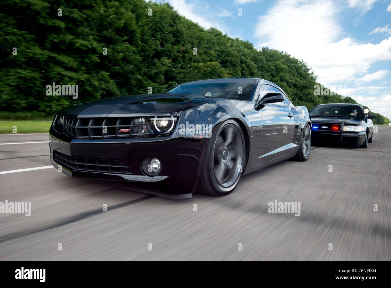 Ford Crown Victoria police car chasing a Chevy Camaro, both lowered on ...