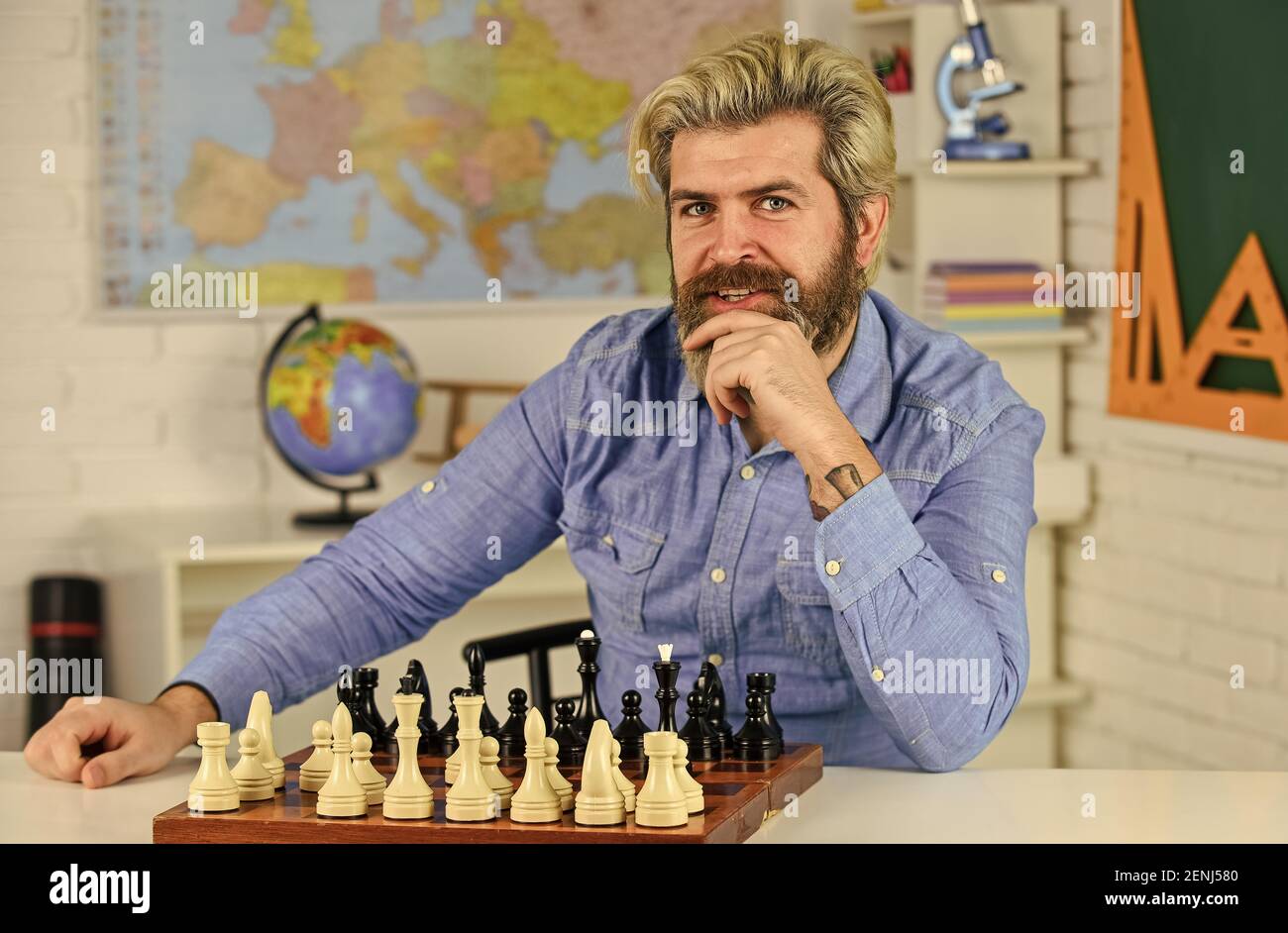 brain works like a muscle. Concentrated man developing chess strategy ...