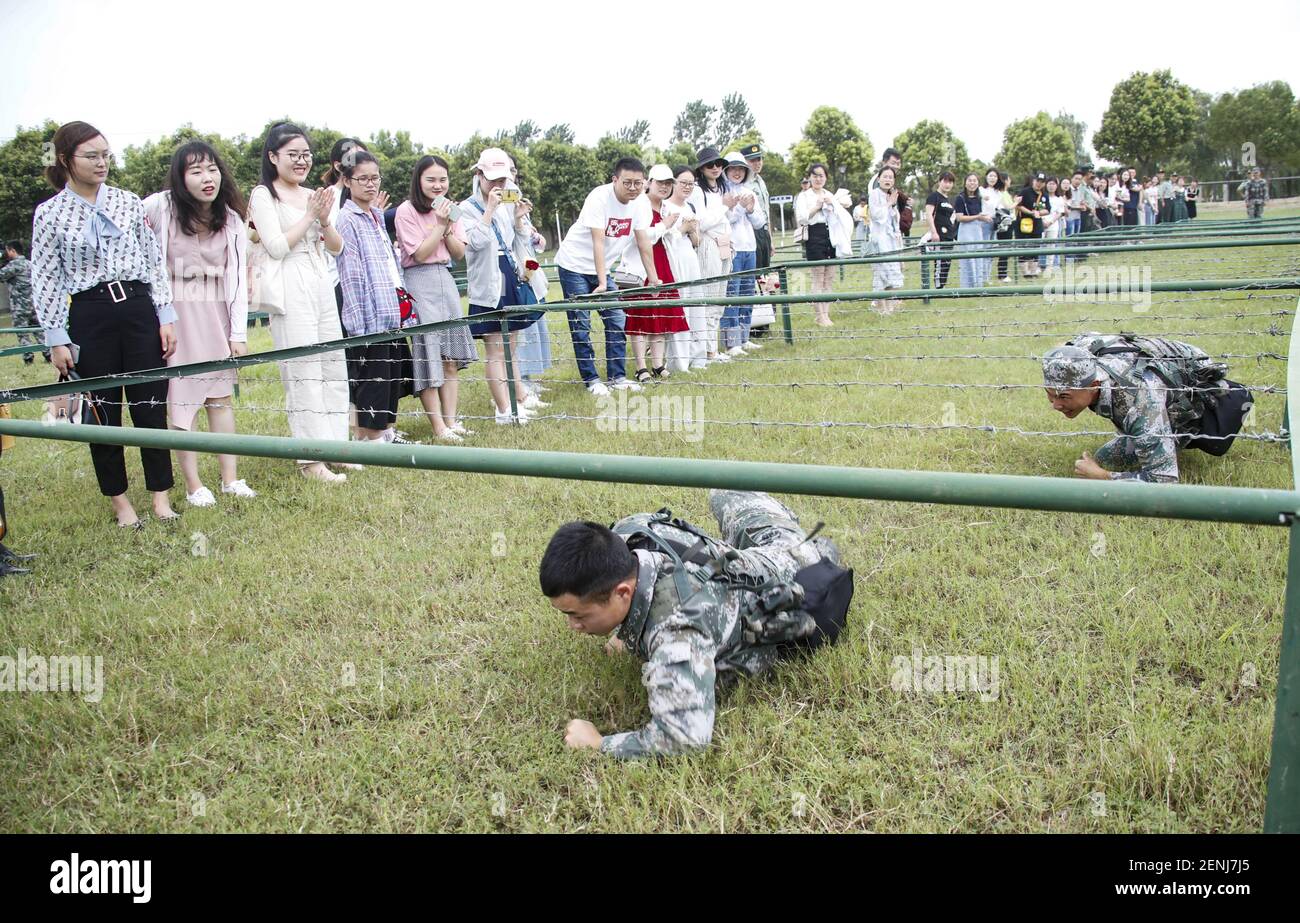 Female participants observe police officers crawling through the ...
