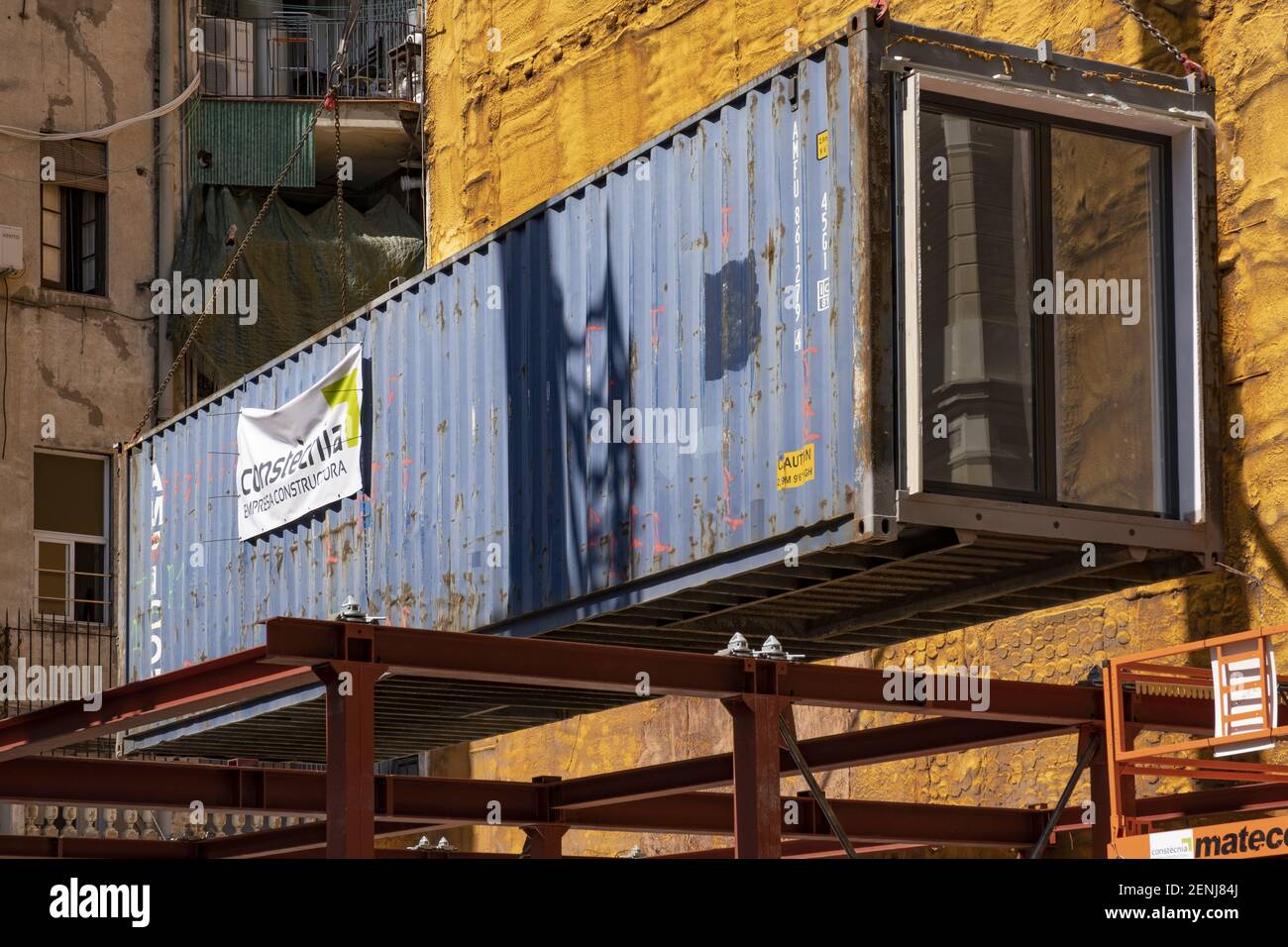 The first housing module is seen elevated by a crane. Press conference ...