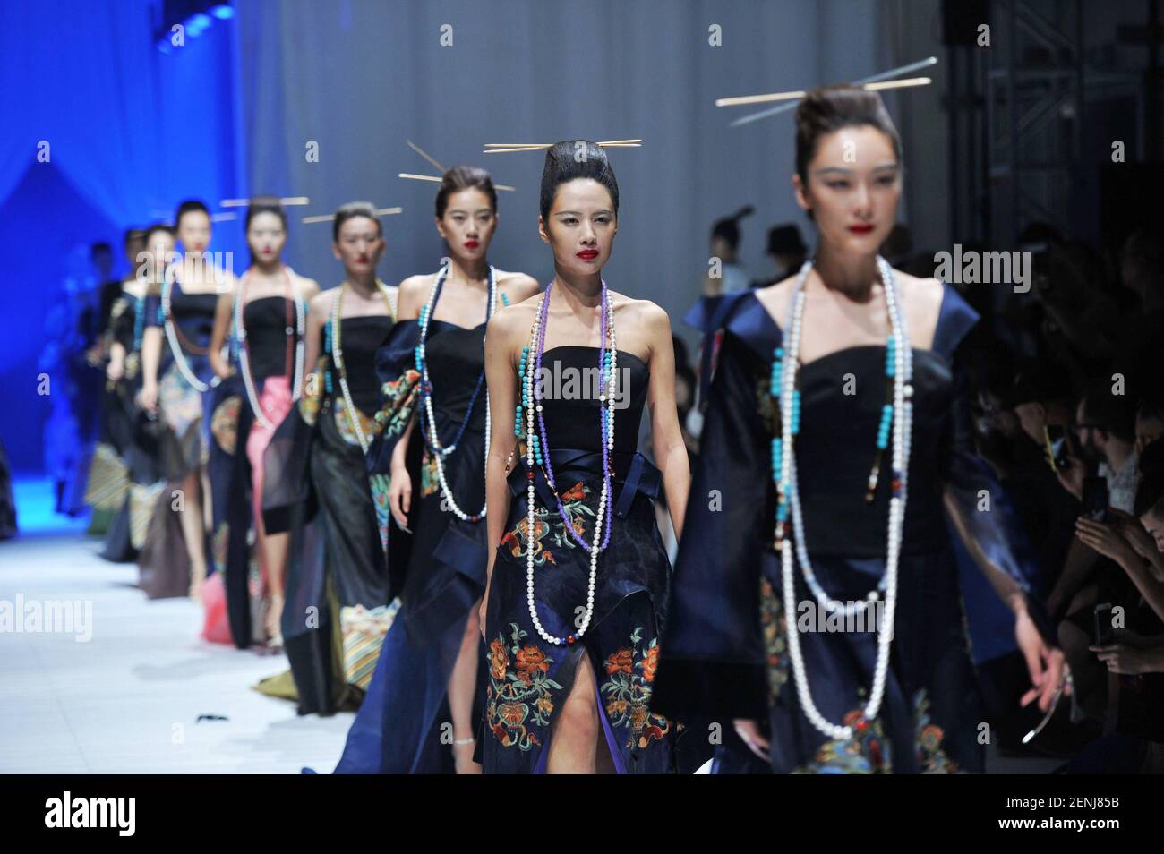 Models display costumes featuring Chinese elements during a film-themed ...