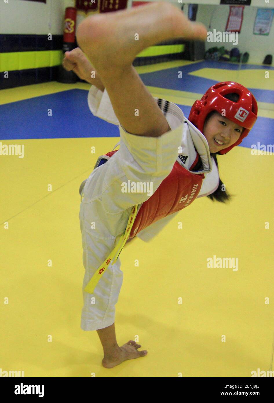 A young Chinese girl practises taekwondo during a training session at a ...