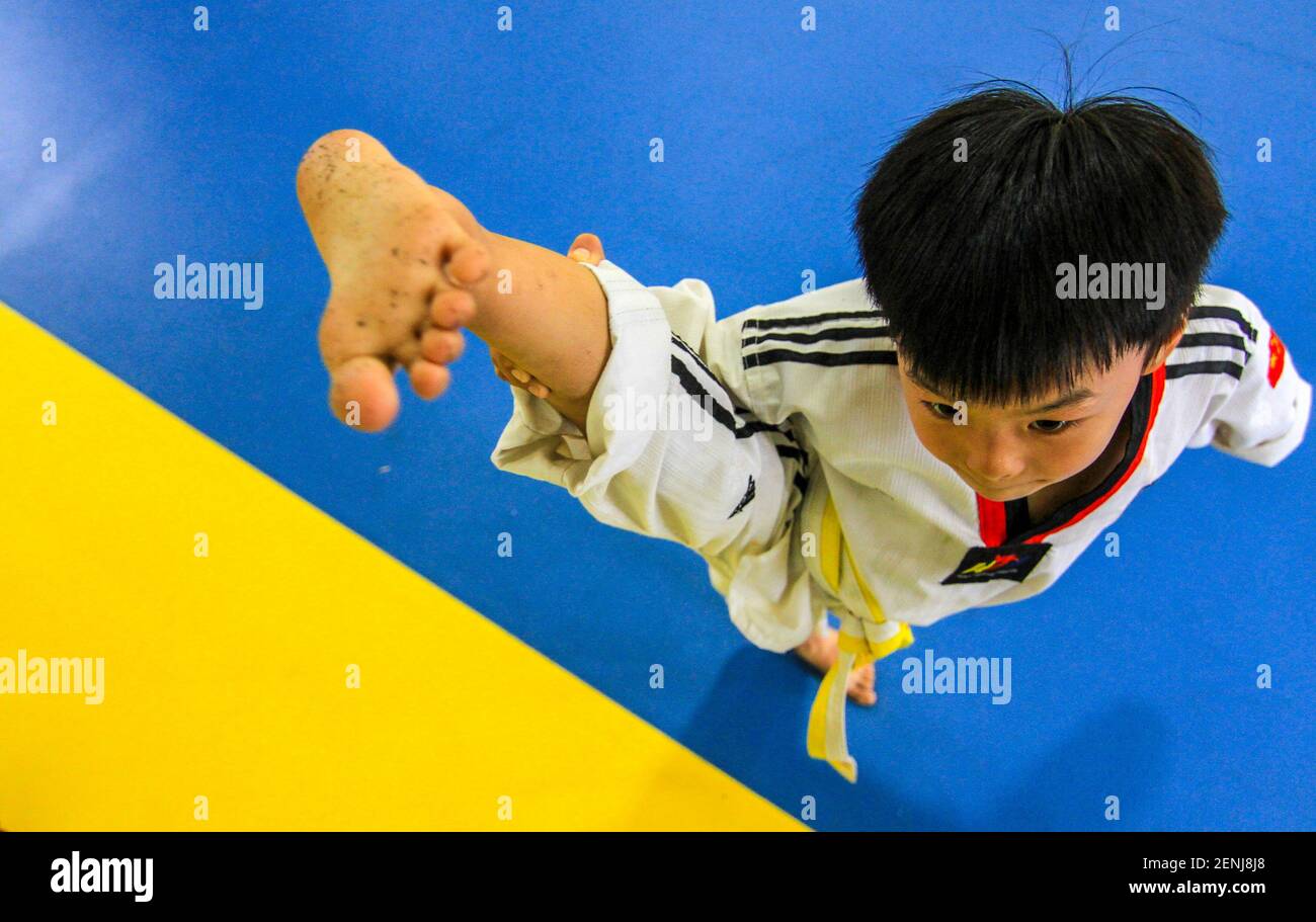 A young Chinese boy practises taekwondo during a training session at a ...