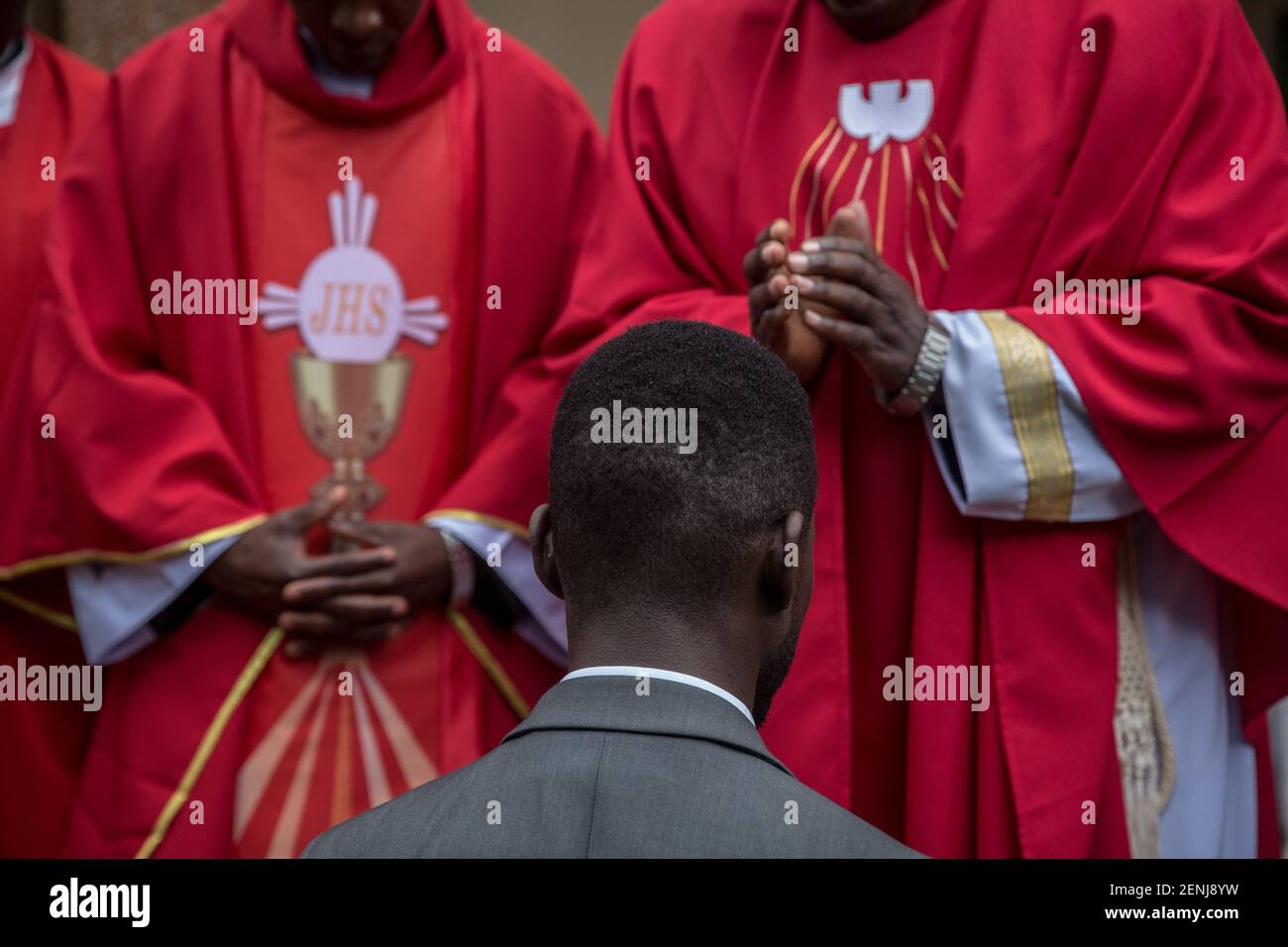 Bobi Wine being blessed by priests at a Catholic thanksgiving during a ...