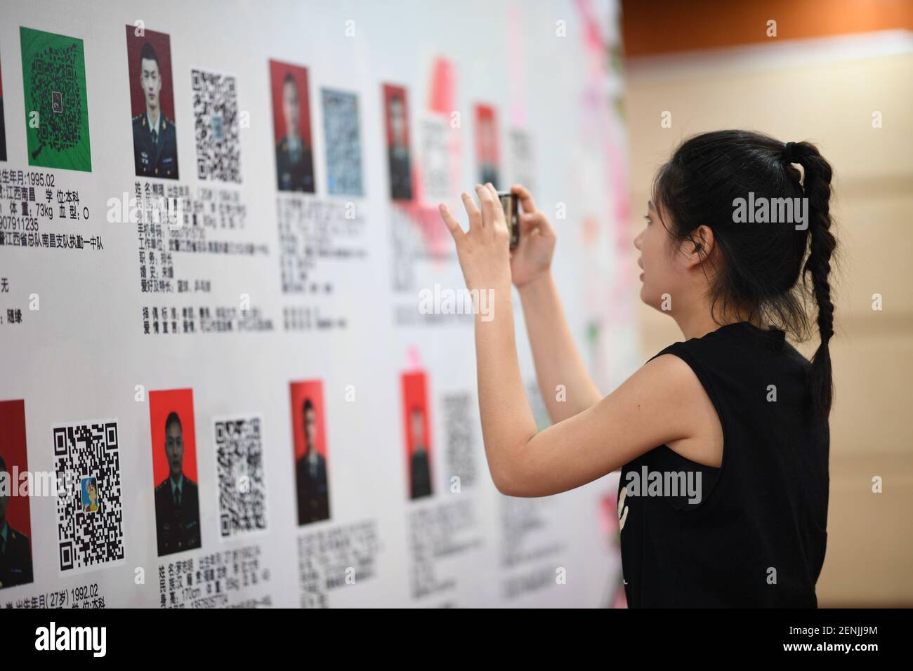 A woman is scanning the QR codes of police officers in Nanchang city ...