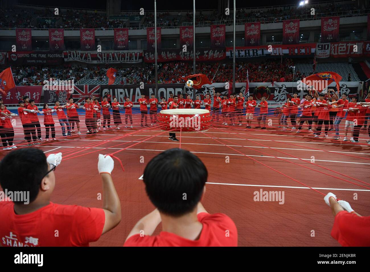 Chinese fans cheer for Shanghai SIPG F.C. with a drum at the Shanghai ...