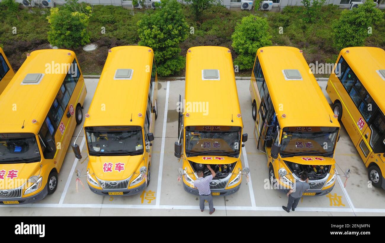 Chinese technicians examine schoolbuses during a checkup session before ...