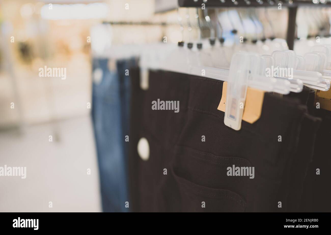 Rack with jeans in clothing store Stock Photo - Alamy