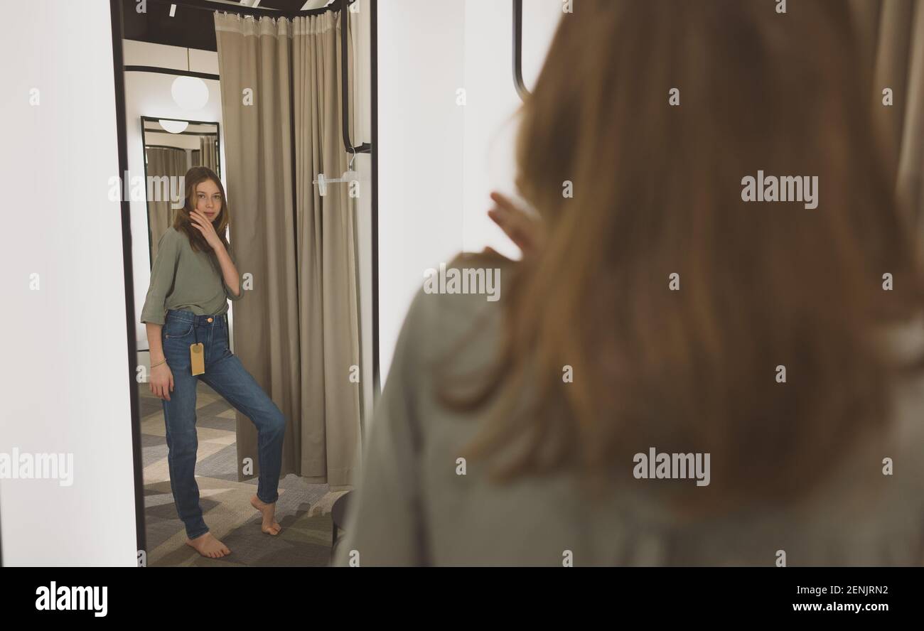 Tween girl standing in fitting room in clothing store Stock Photo - Alamy