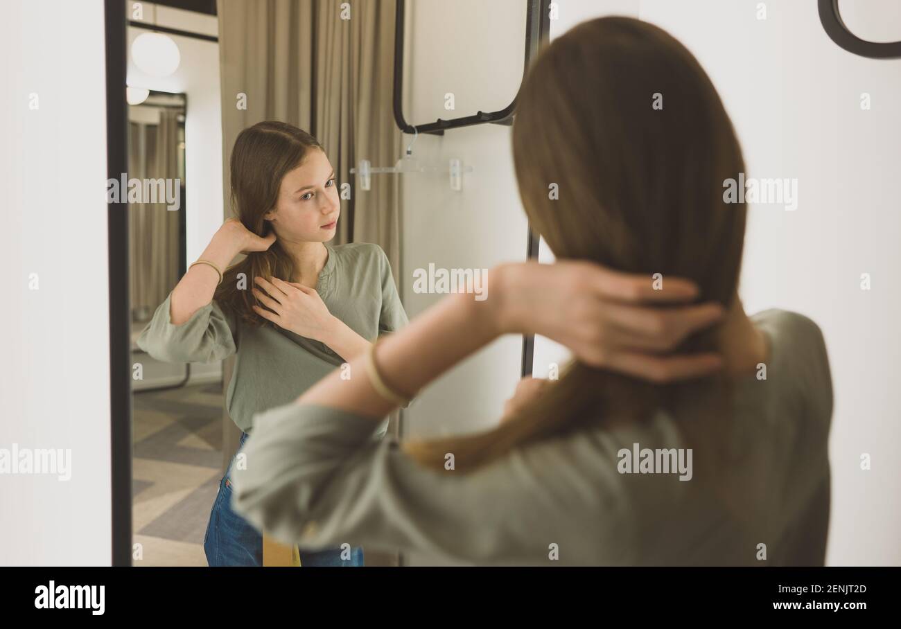 Tween girl standing in fitting room in clothing store Stock Photo - Alamy
