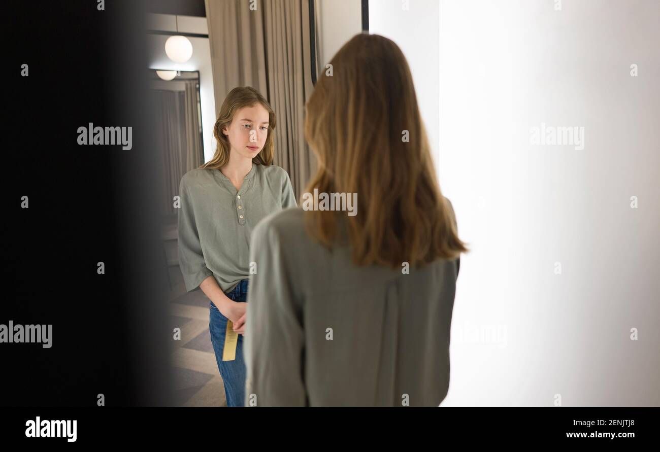 Tween girl standing in fitting room in clothing store Stock Photo - Alamy