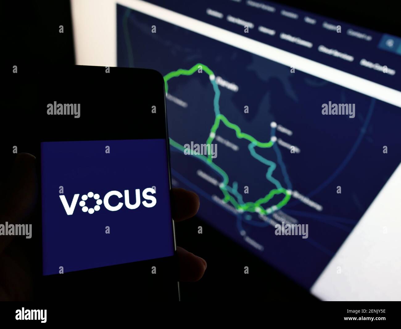 Person holding mobile phone with logo of Australian telecommunications ...