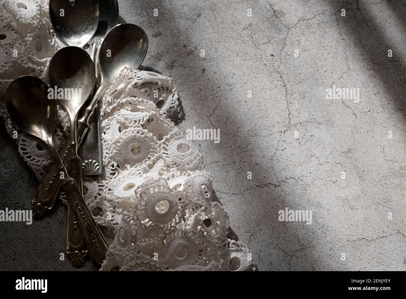 Antique silver spoons with handmade embroidery napkin Stock Photo - Alamy